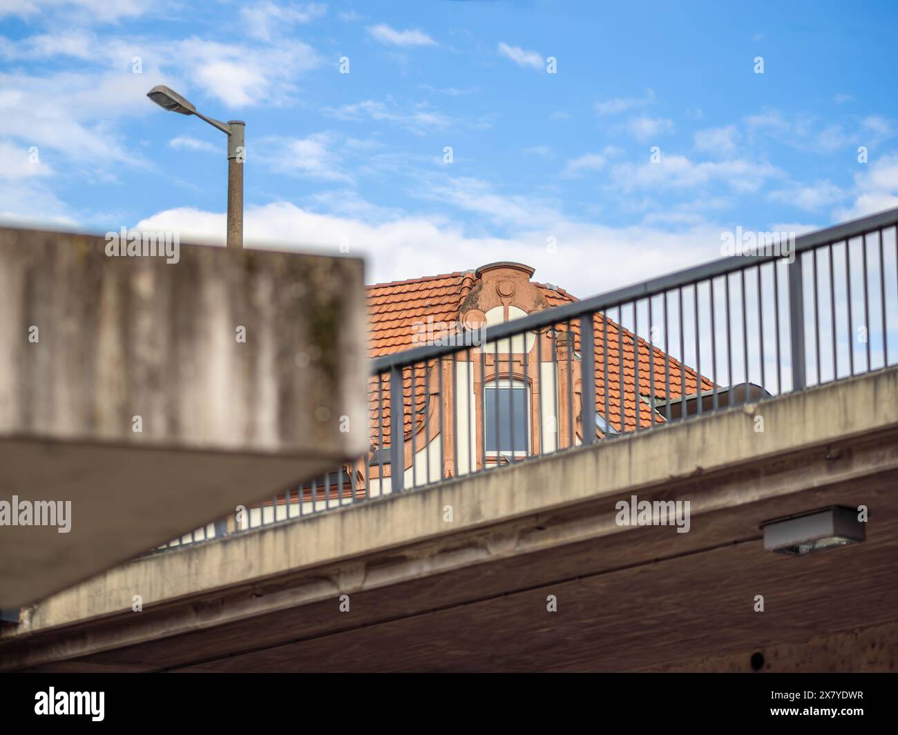 An urban scene featuring a concrete structure with a railing, a ...