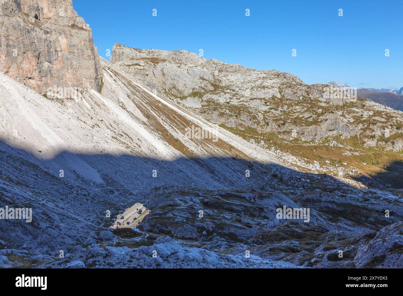 Reflections on small lake at the foots of rocky walls of Pala di Popera ...