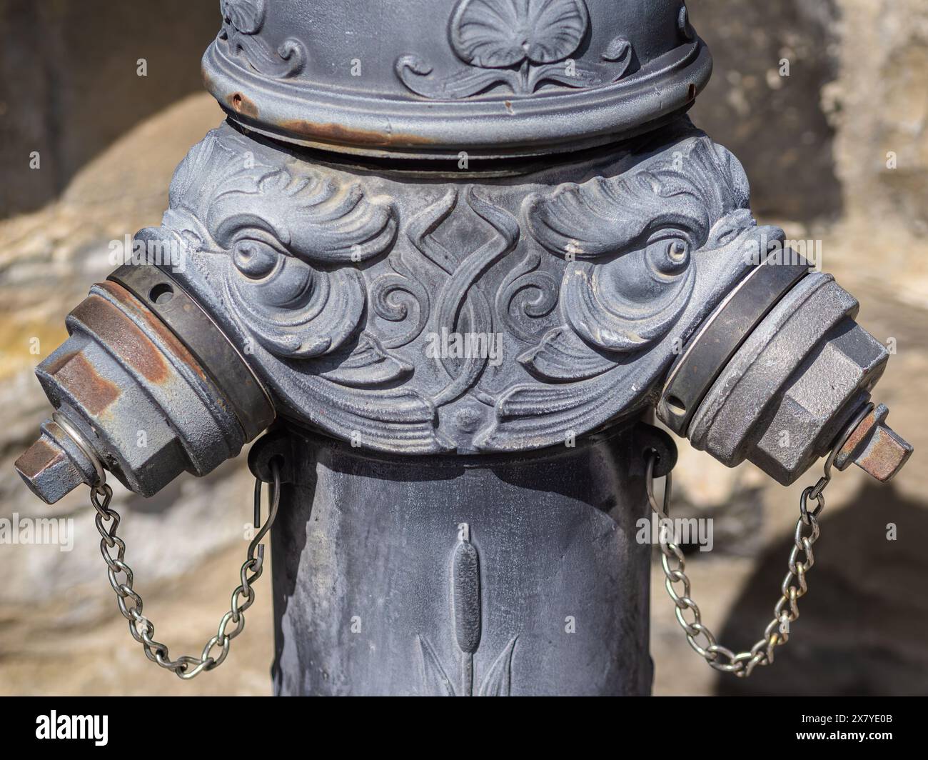 A vintage cast iron fire hydrant adorned with ornate floral designs ...