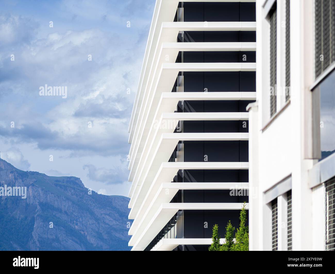 A modern building with white, horizontal slabs and geometric facade ...