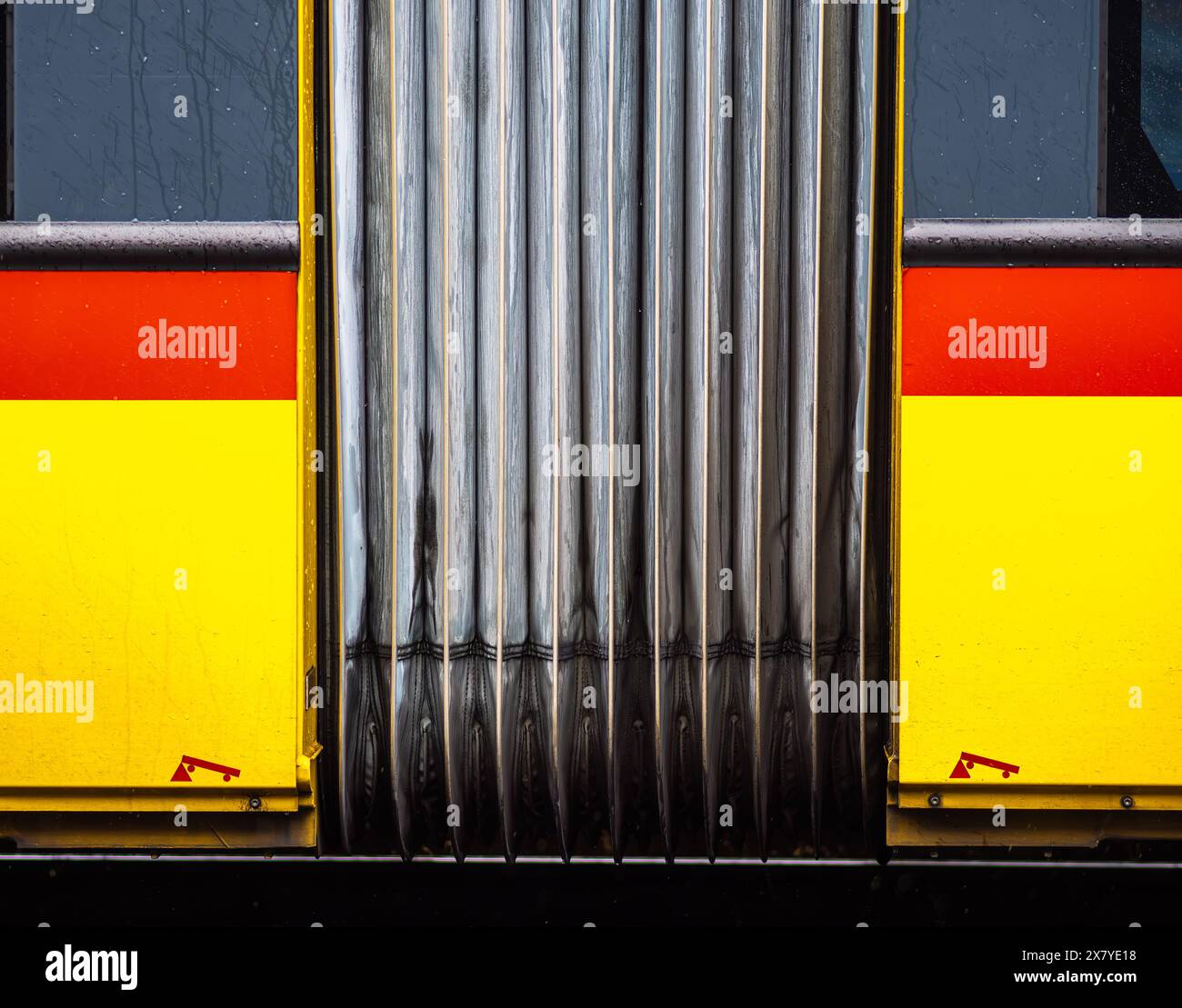 Close-up of a colorful urban train connection mechanism with accordion ...