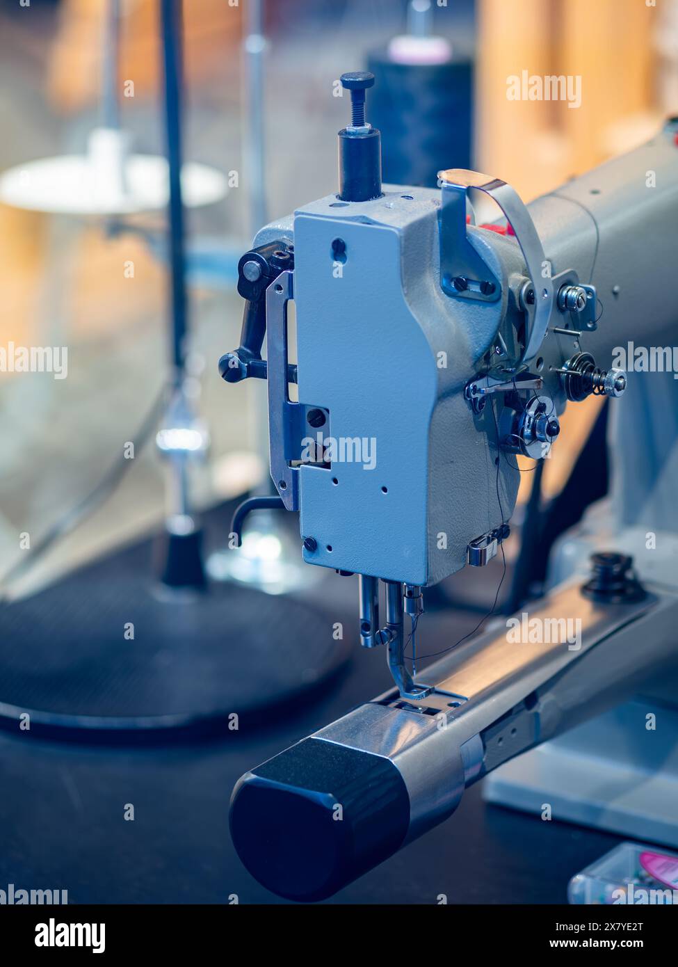 Close-up view of a sturdy, industrial sewing machine on a worktable ...