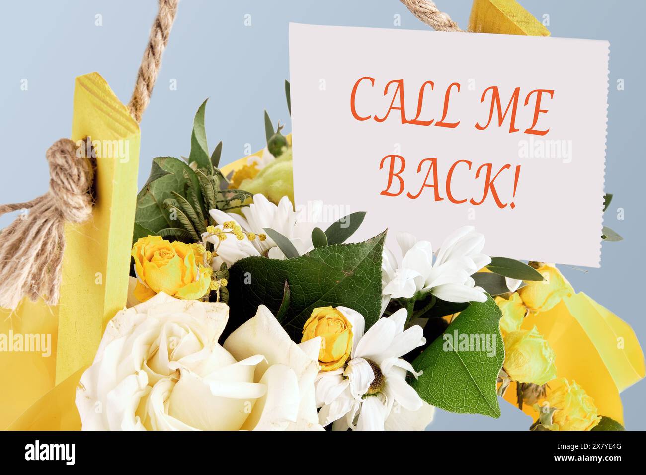 CALL ME BACK text written on a card inserted into a bouquet of flowers ...
