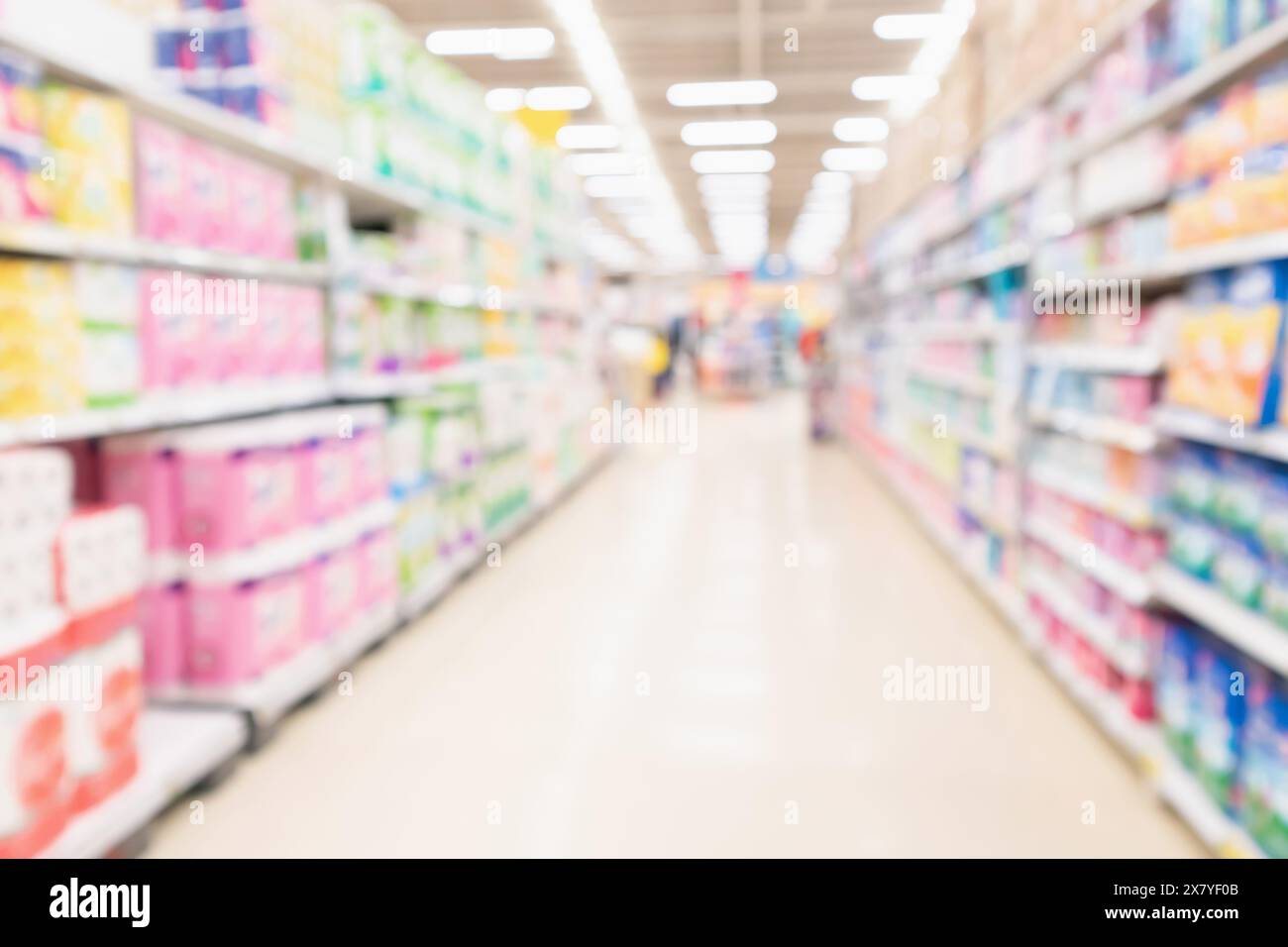 Abstract blurred supermarket aisle and shelves with various toilet ...