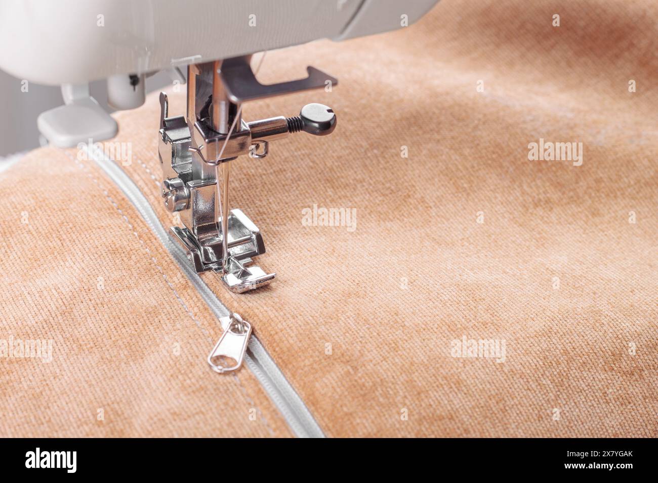 Modern sewing machine special presser foot with beige fabric and thread ...