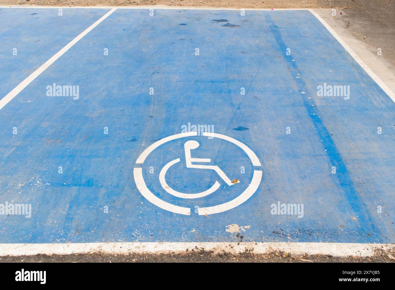 disable sign on blue paint color car park Stock Photo - Alamy