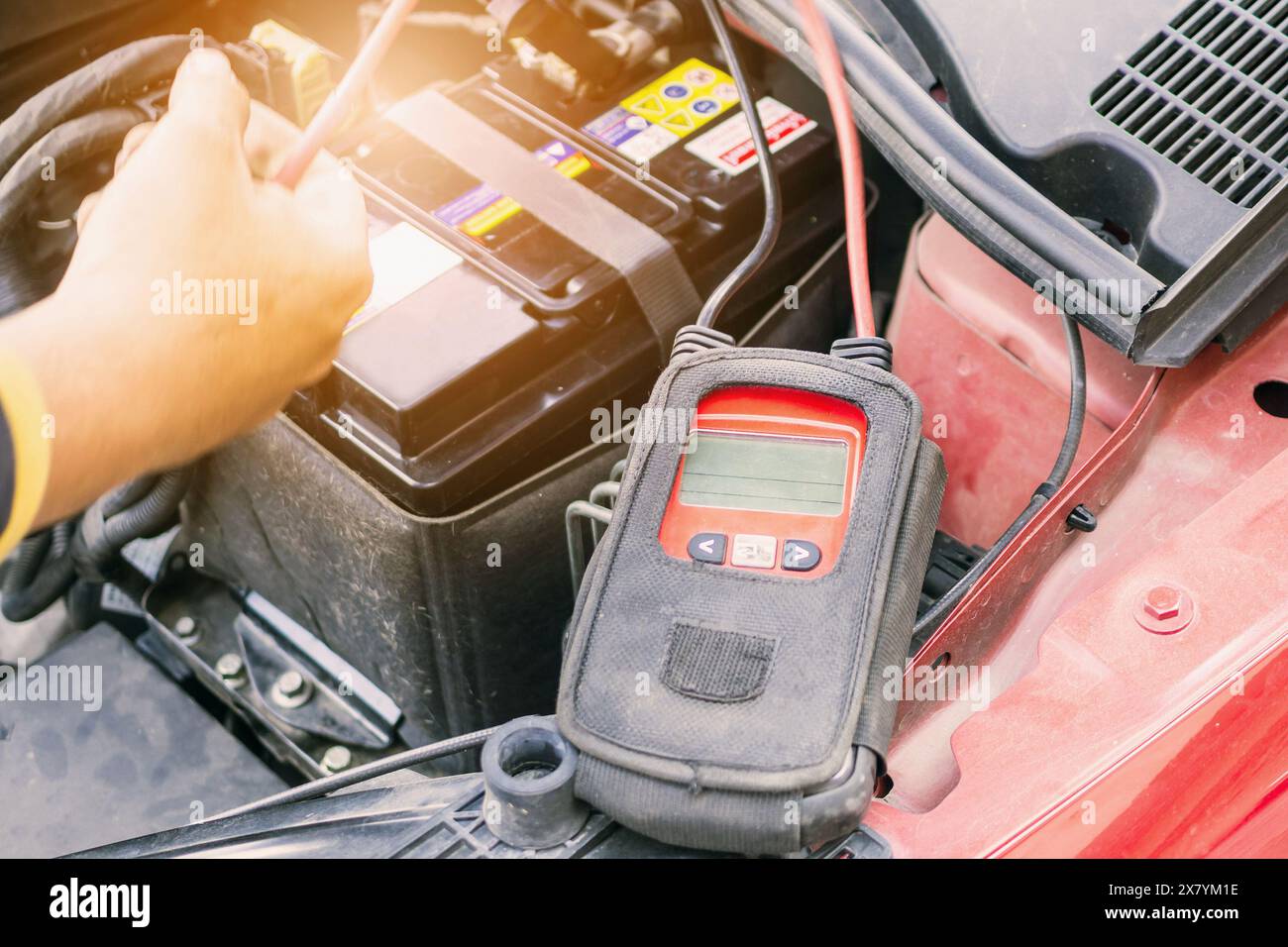 car mechanic use voltmeter to check car battery voltage level Stock ...