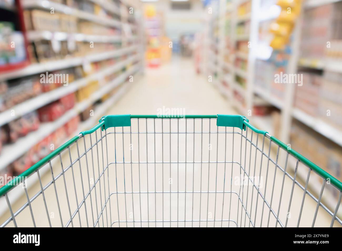 Empty shopping cart with abstract blur supermarket discount store aisle ...