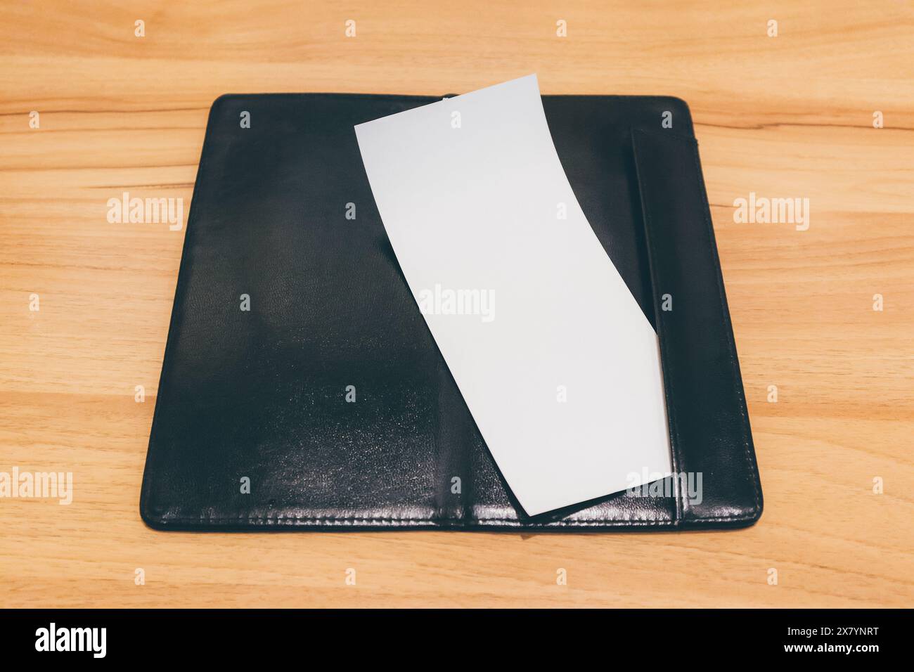 Blank empty white paper in restaurant payment billing receipt folder on ...