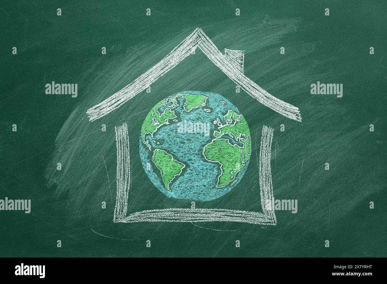 A chalk drawing of Earth is encased within a house outline on a green ...