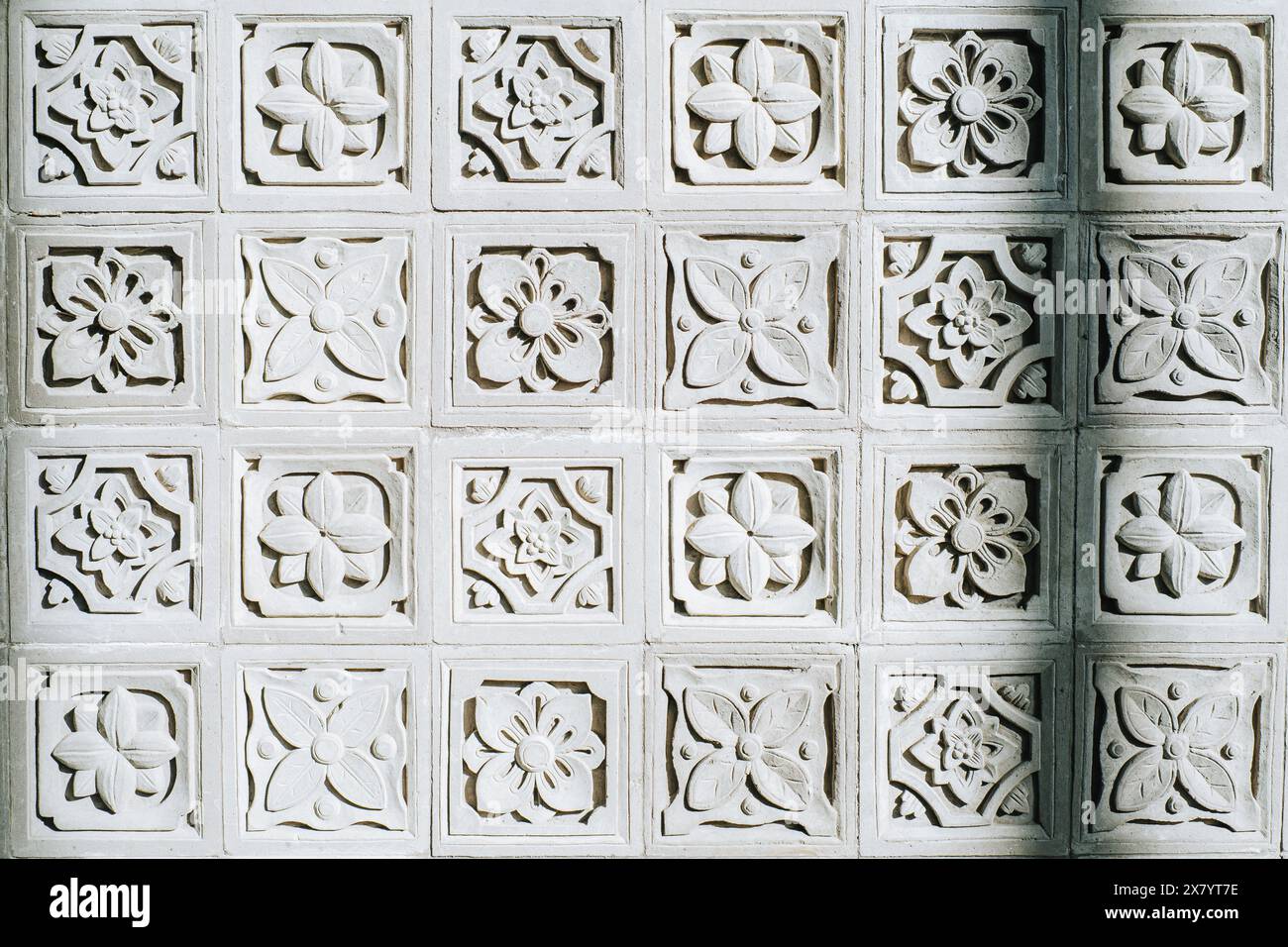 Tropical style wall with floral and geometric carved into square panels ...