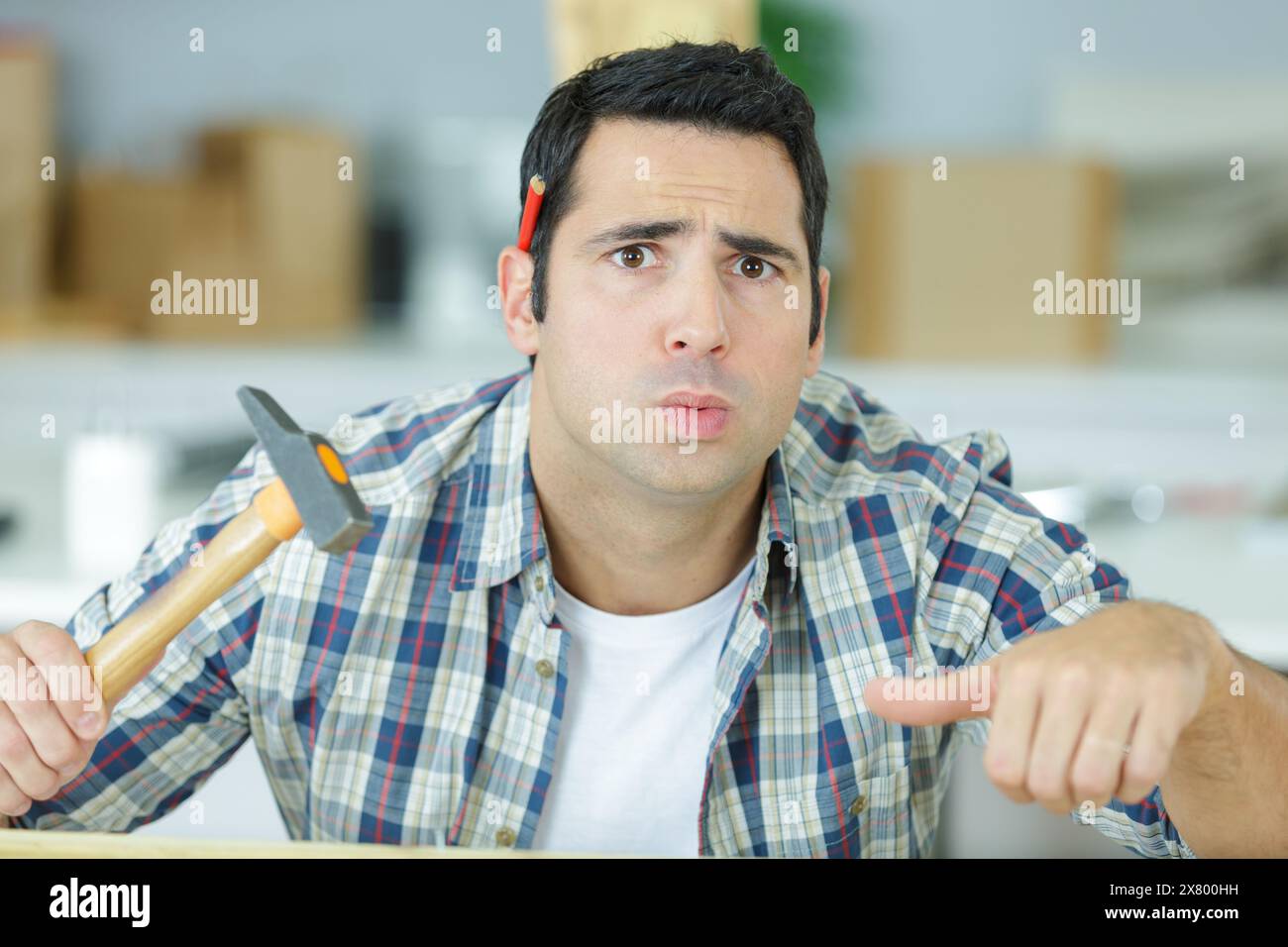 man tapped a finger with a hammer Stock Photo - Alamy