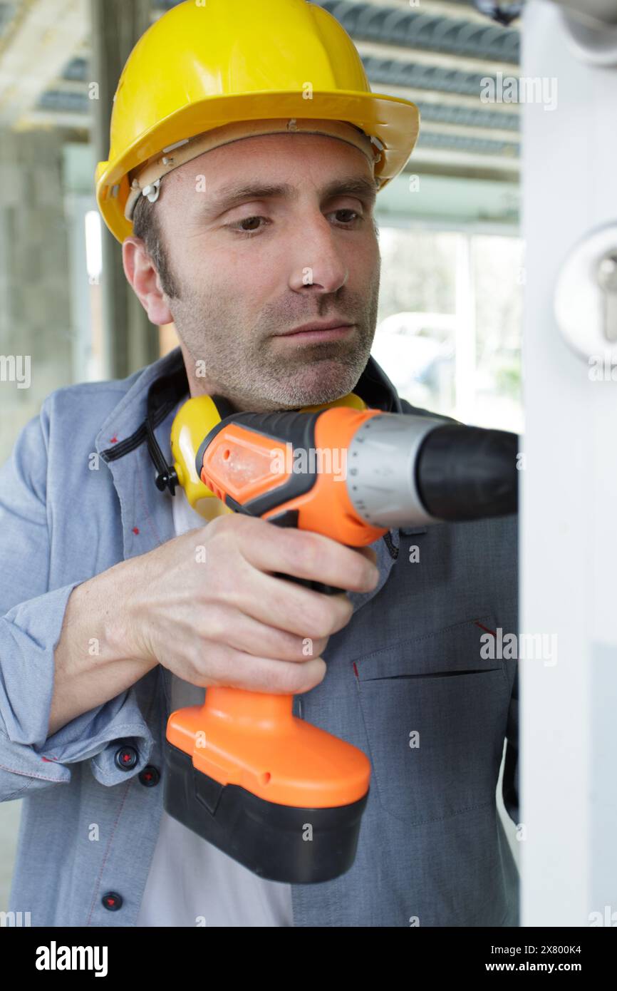 Skilled worker using drill hi-res stock photography and images - Alamy
