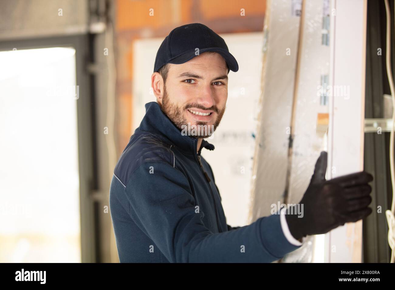professional builder sheathe walls with insulation Stock Photo - Alamy