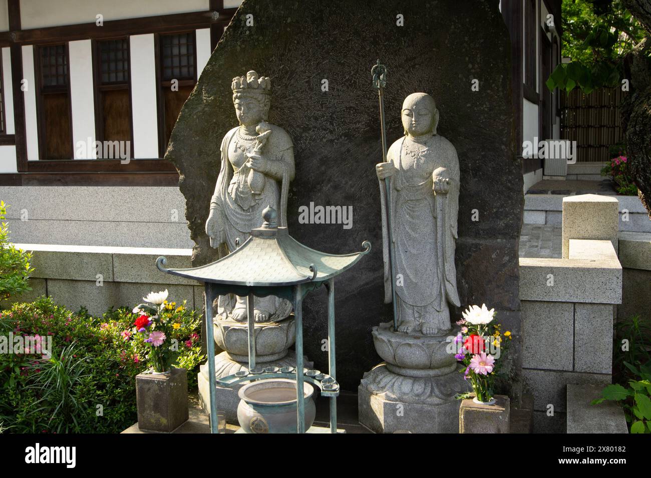 Two standing Buddha statues at a Japanese shrine in Kamakura ...