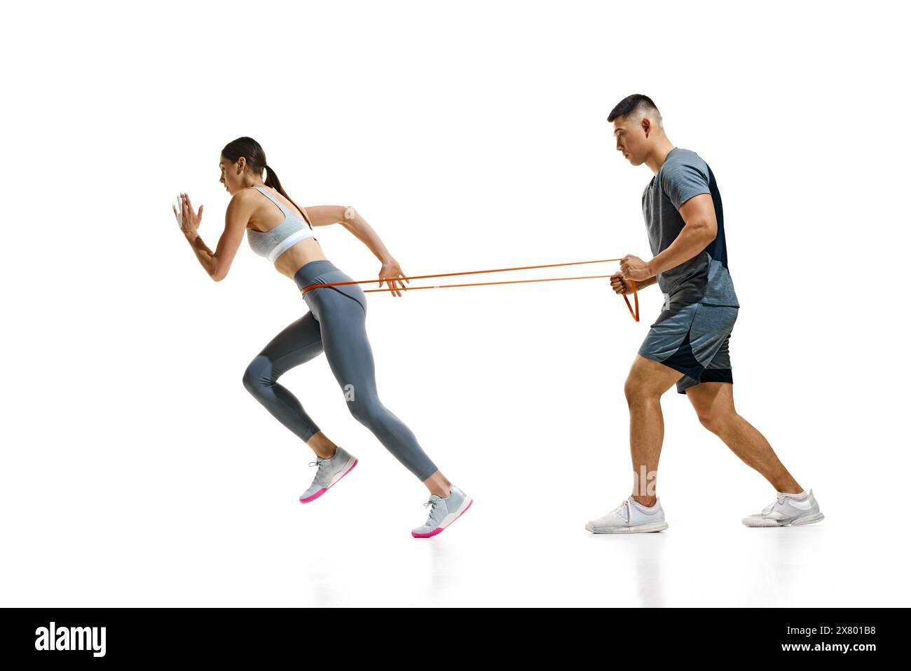 Dynamic image man and woman performing resistance training exercise ...