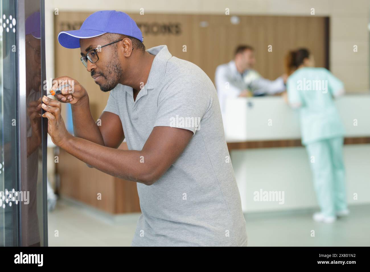 construction worker installing window in a hospital Stock Photo - Alamy