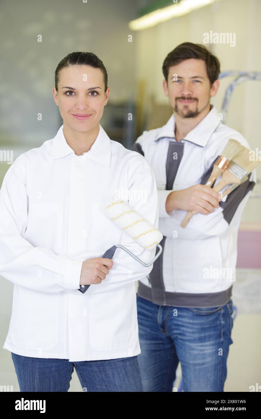 male and female painting and decorating team Stock Photo - Alamy