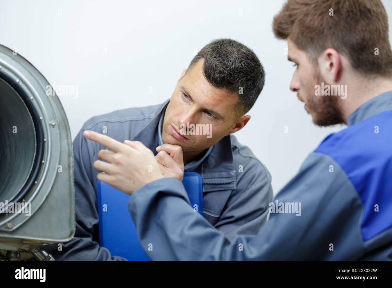 Workers on mechanical device hi-res stock photography and images - Alamy