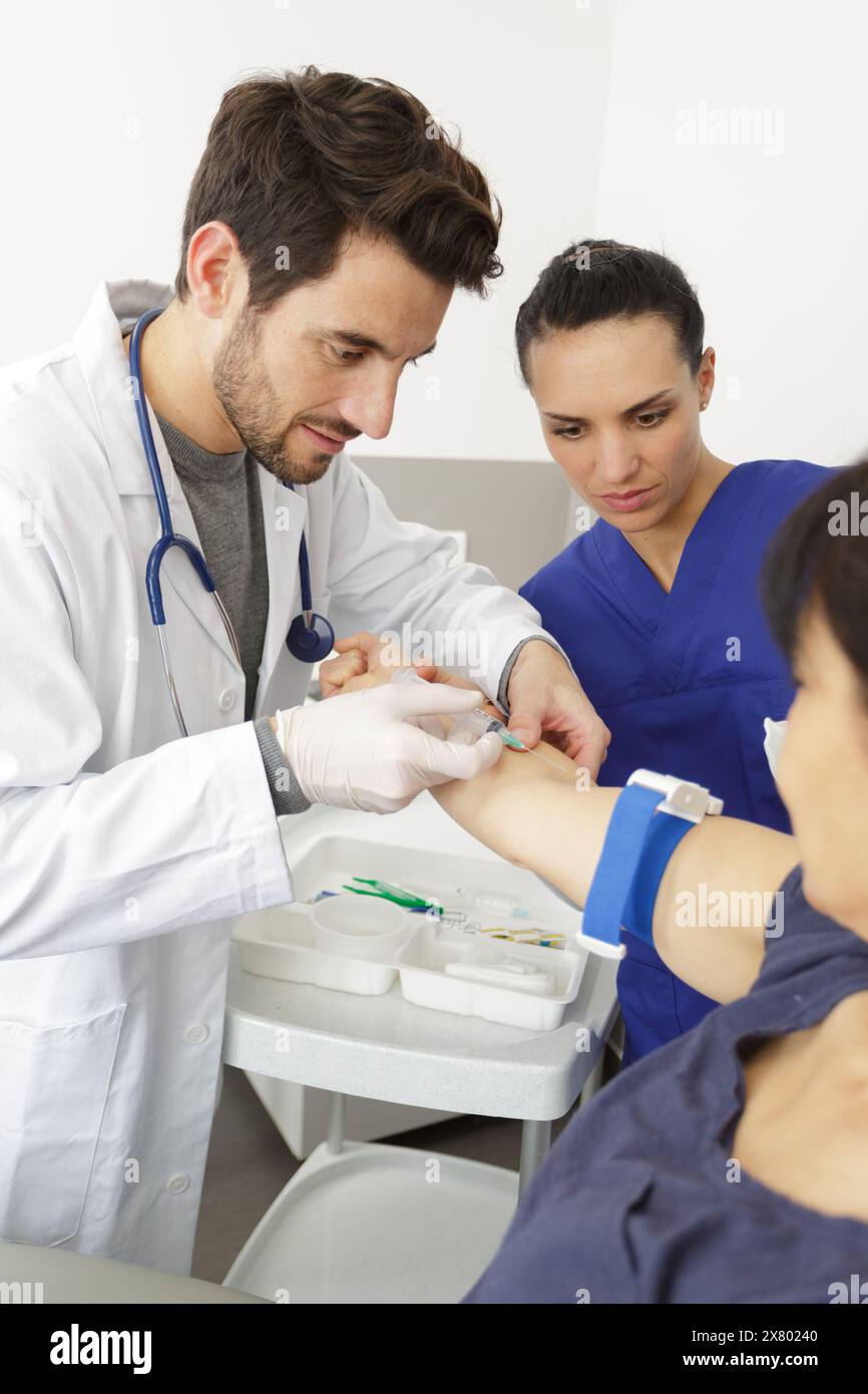 male medical professional holding arm of a retired patient Stock Photo ...