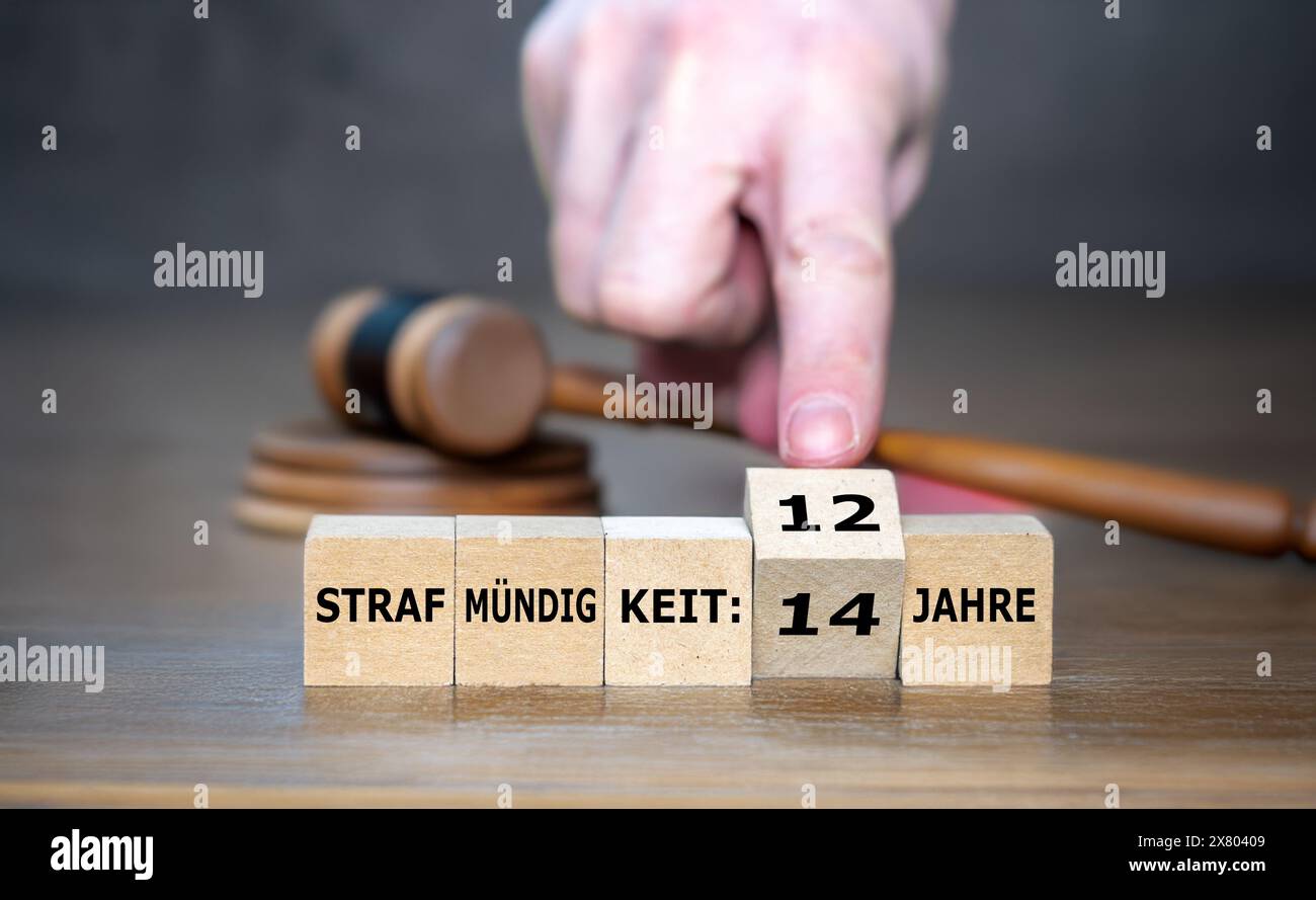 Hand turns wooden cubes and changes the German expression ...