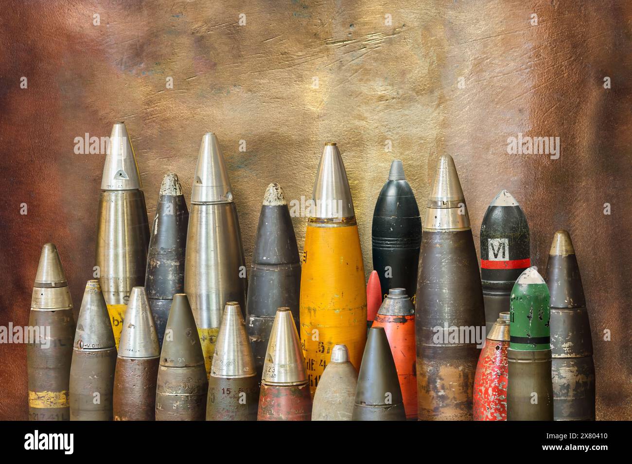 Row of weathered antique world war two bombs in front of a weathered ...