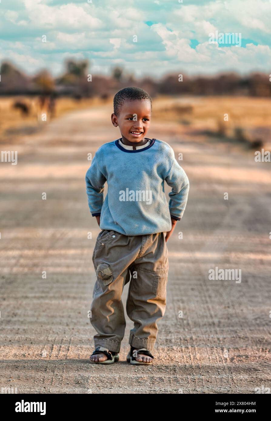 village single smiling african kid on a dusty dirt country road Stock ...