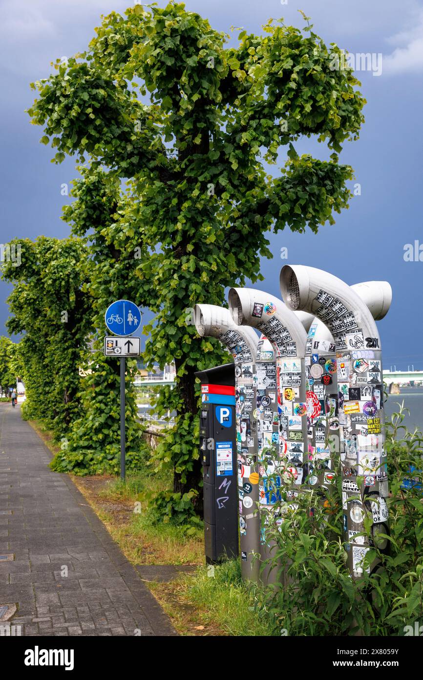 ventilation pipes on the banks of the Rhine covered with many stickers ...
