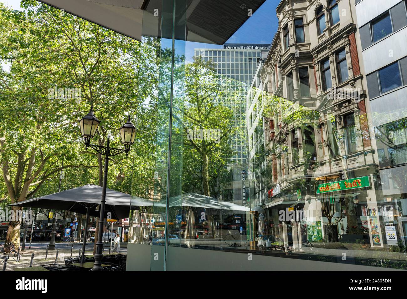 houses and trees are reflected in the window of the Bar Azure on ...