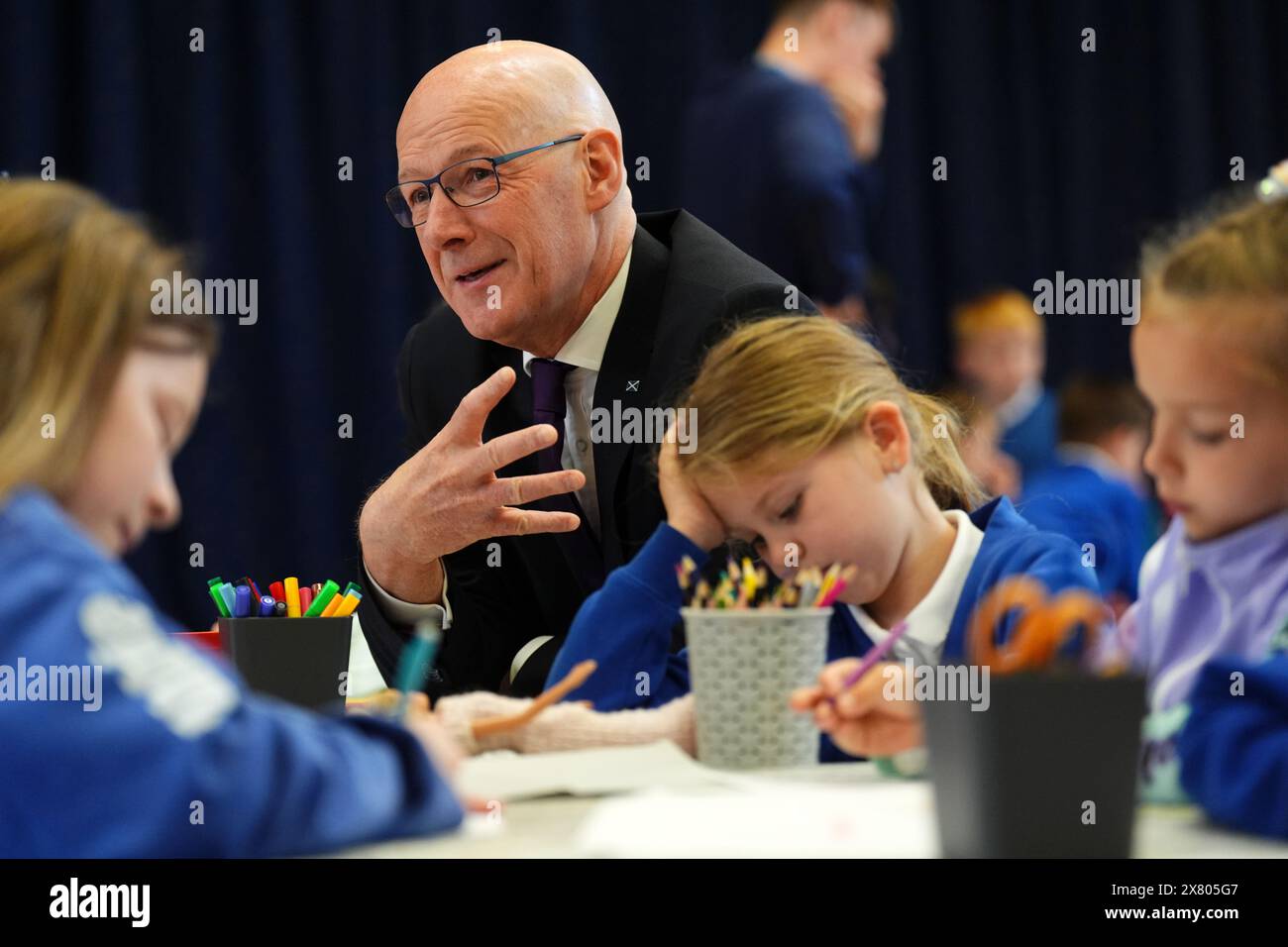 First Minister John Swinney chats to pupils during a visit to a ...