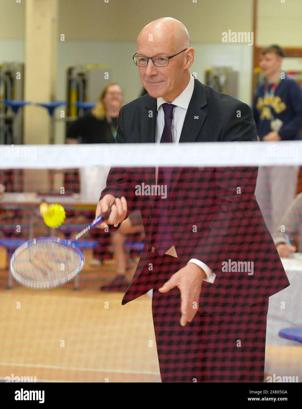 First Minister John Swinney plays badminton with pupils during a visit ...