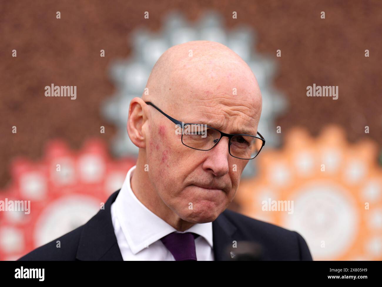 First Minister John Swinney speaks to the media during a visit to a ...
