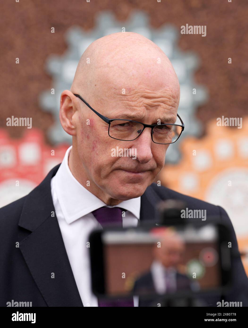 First Minister John Swinney speaks to the media during a visit to a ...