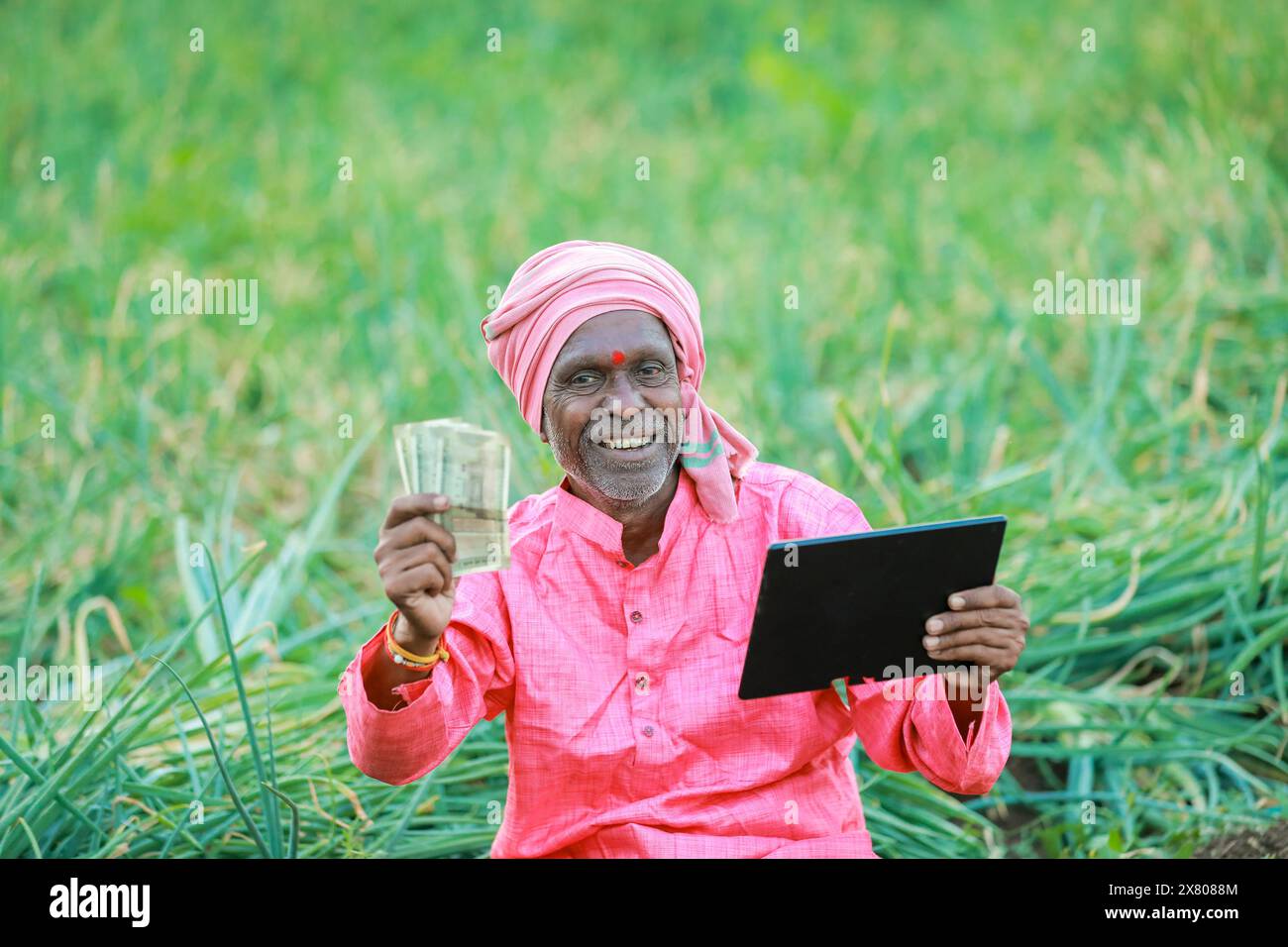 Indian farmer holding tablet Stock Photo - Alamy