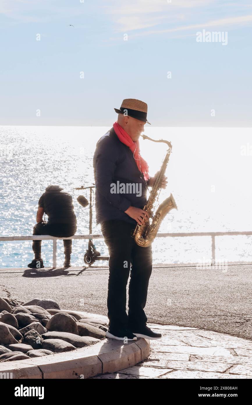 Nice, France - November 7, 2022: Man playing the saxophone for passers ...