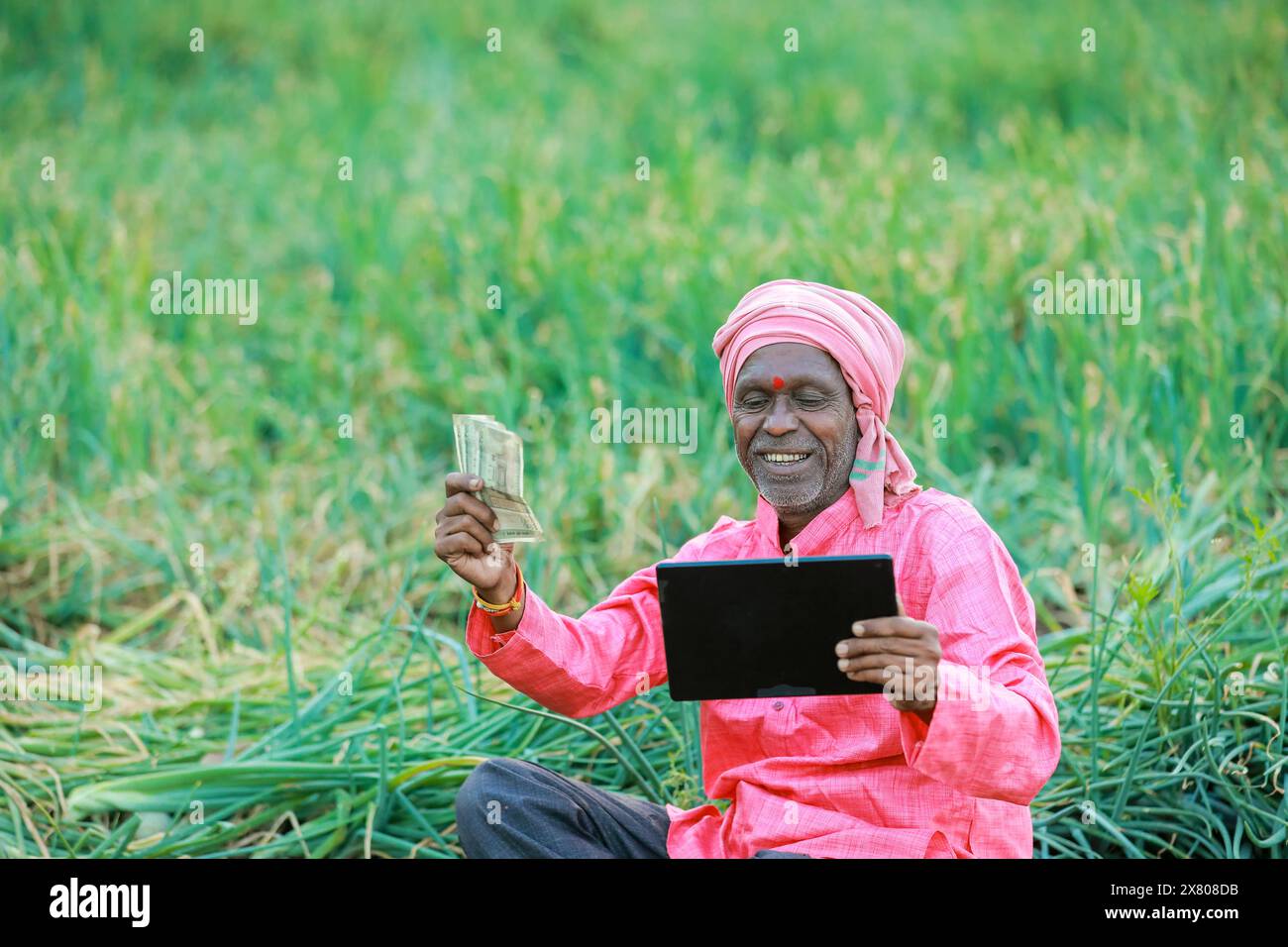 Indian farmer holding tablet Stock Photo - Alamy