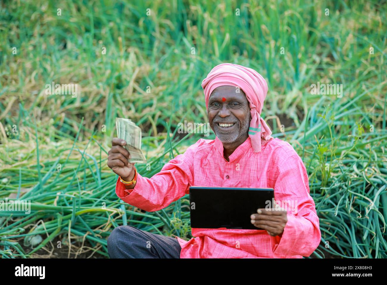 Indian farmer holding tablet Stock Photo - Alamy