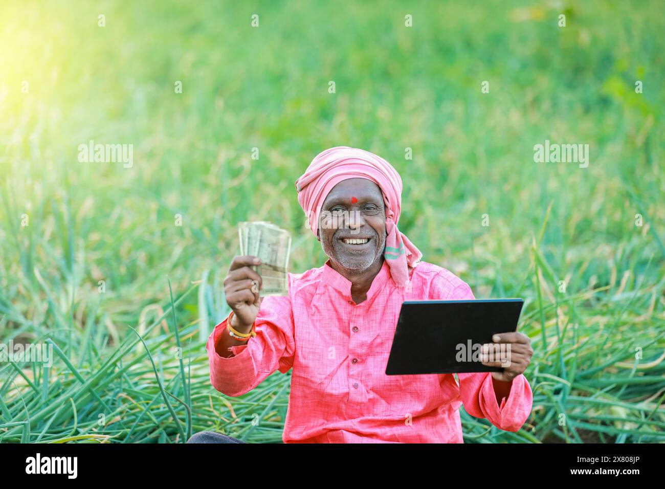 Indian farmer holding tablet Stock Photo - Alamy