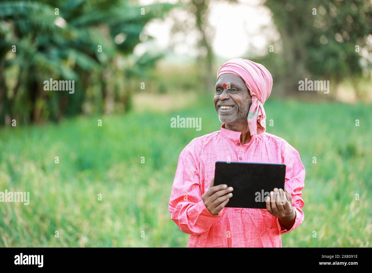 Indian farmer holding tablet Stock Photo - Alamy