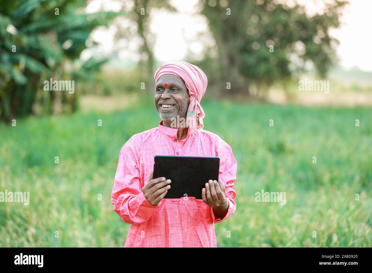 Indian farmer holding tablet Stock Photo - Alamy