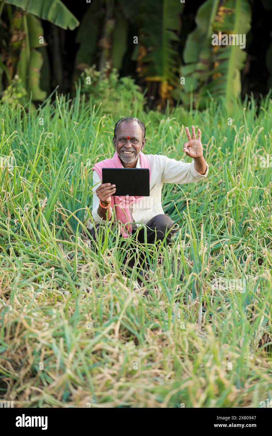 Indian farmer holding tablet Stock Photo - Alamy