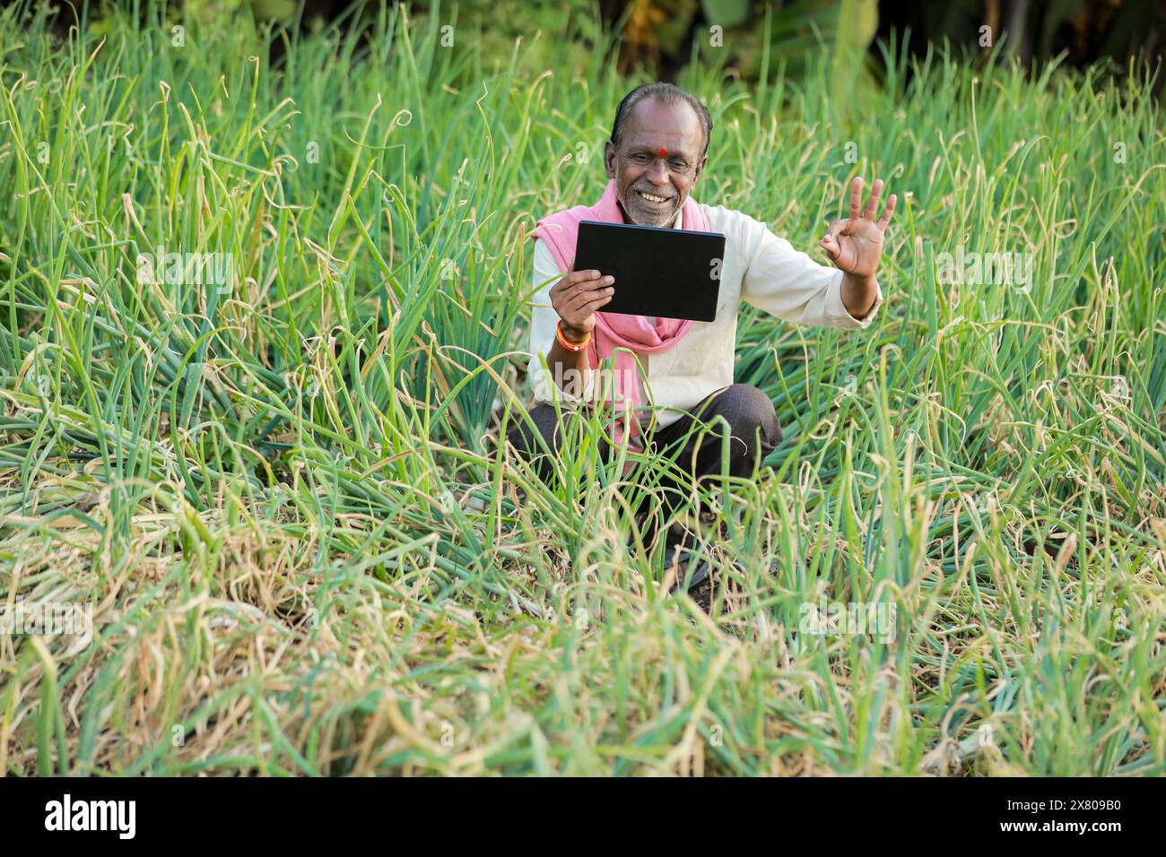 Indian farmer holding tablet Stock Photo - Alamy