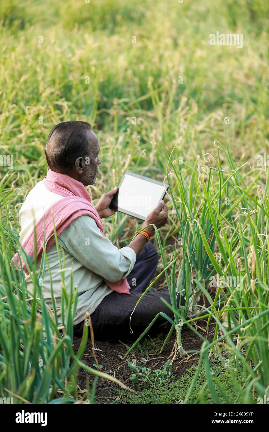 Indian farmer holding tablet Stock Photo - Alamy