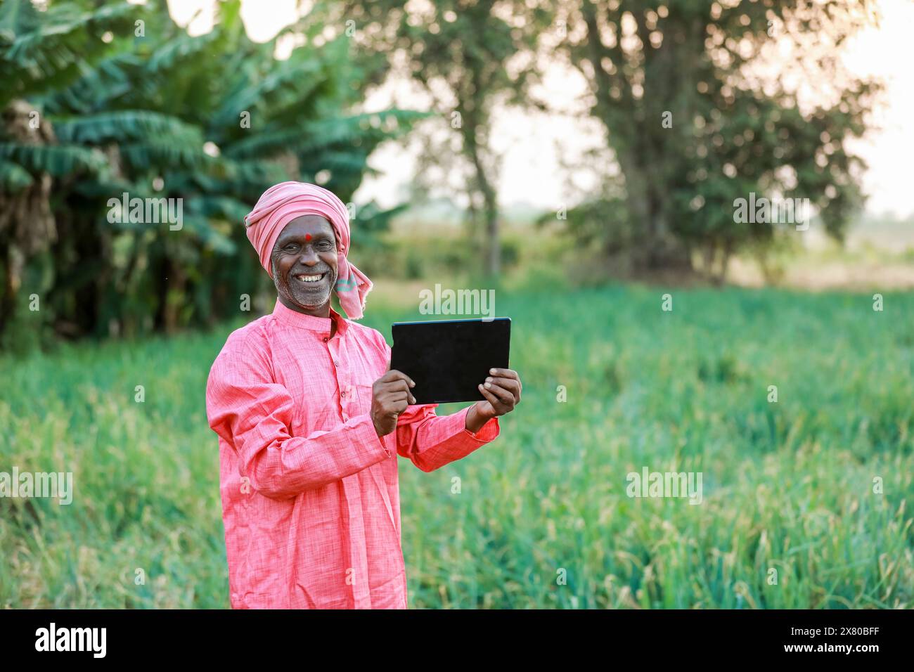 Indian farmer holding tablet Stock Photo - Alamy