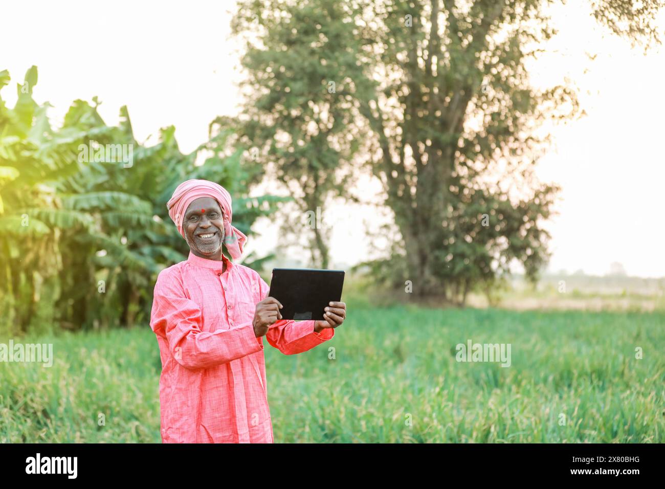 Indian farmer holding tablet Stock Photo - Alamy