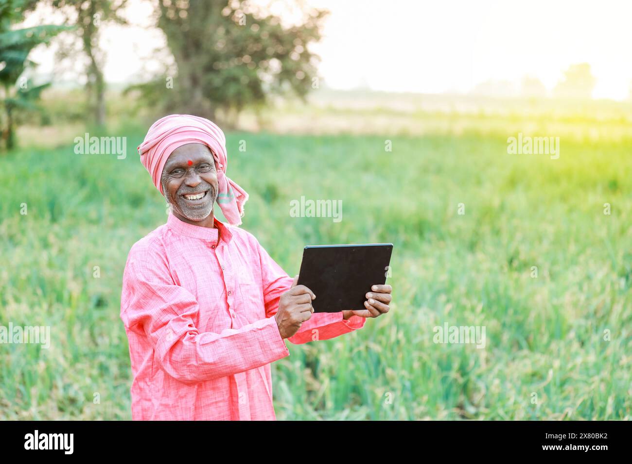 Indian farmer holding tablet Stock Photo - Alamy