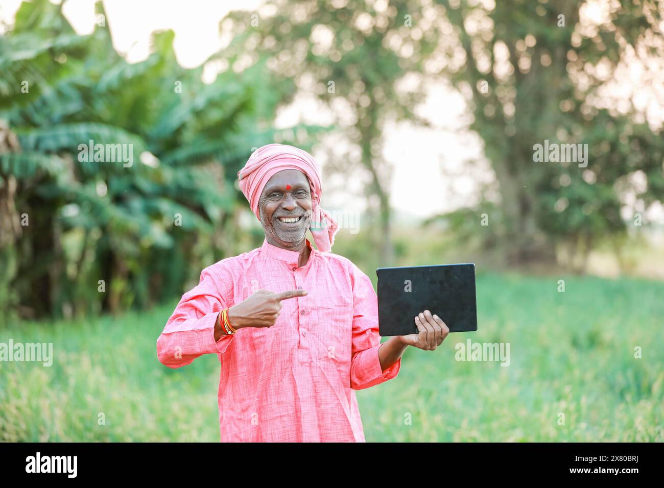 Indian farmer holding tablet Stock Photo - Alamy