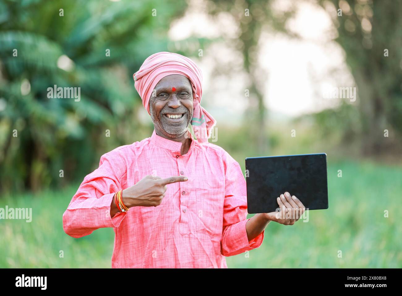 Indian farmer holding tablet Stock Photo - Alamy