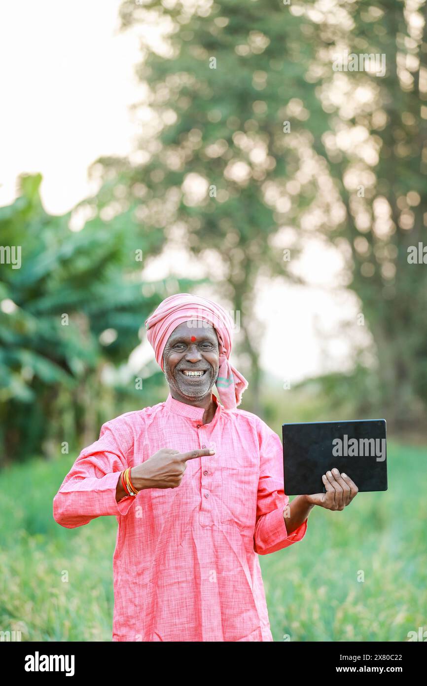 Indian farmer holding tablet Stock Photo - Alamy