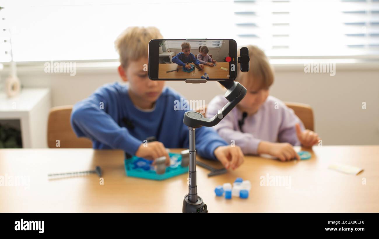 Kids play a new board game for their blog, recording a fun and ...